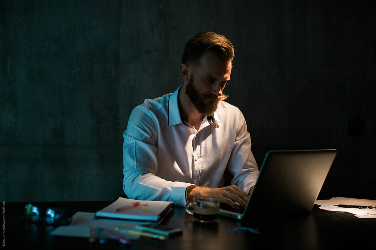 "Man Working Late In The Office" by Stocksy Contributor "Mosuno" - Stocksy