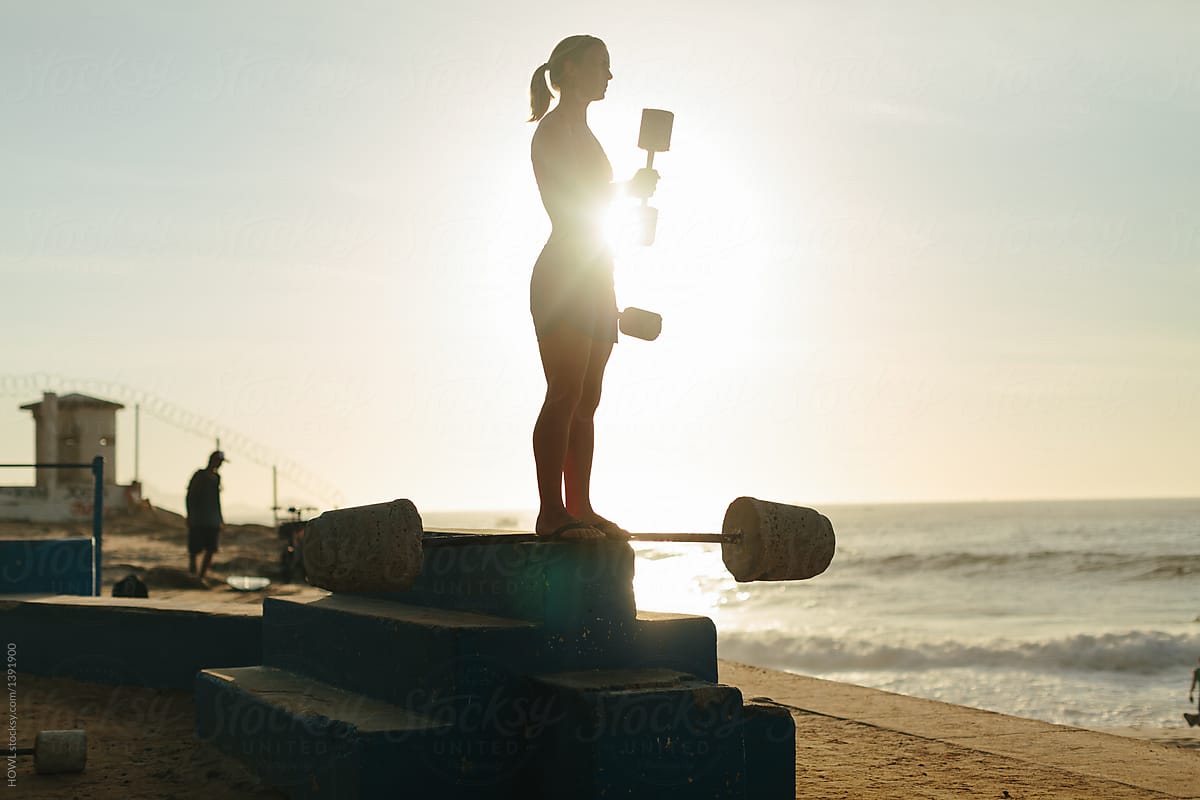 "Strong Woman Exercises On The Beach" by Stocksy Contributor "HOWL ...
