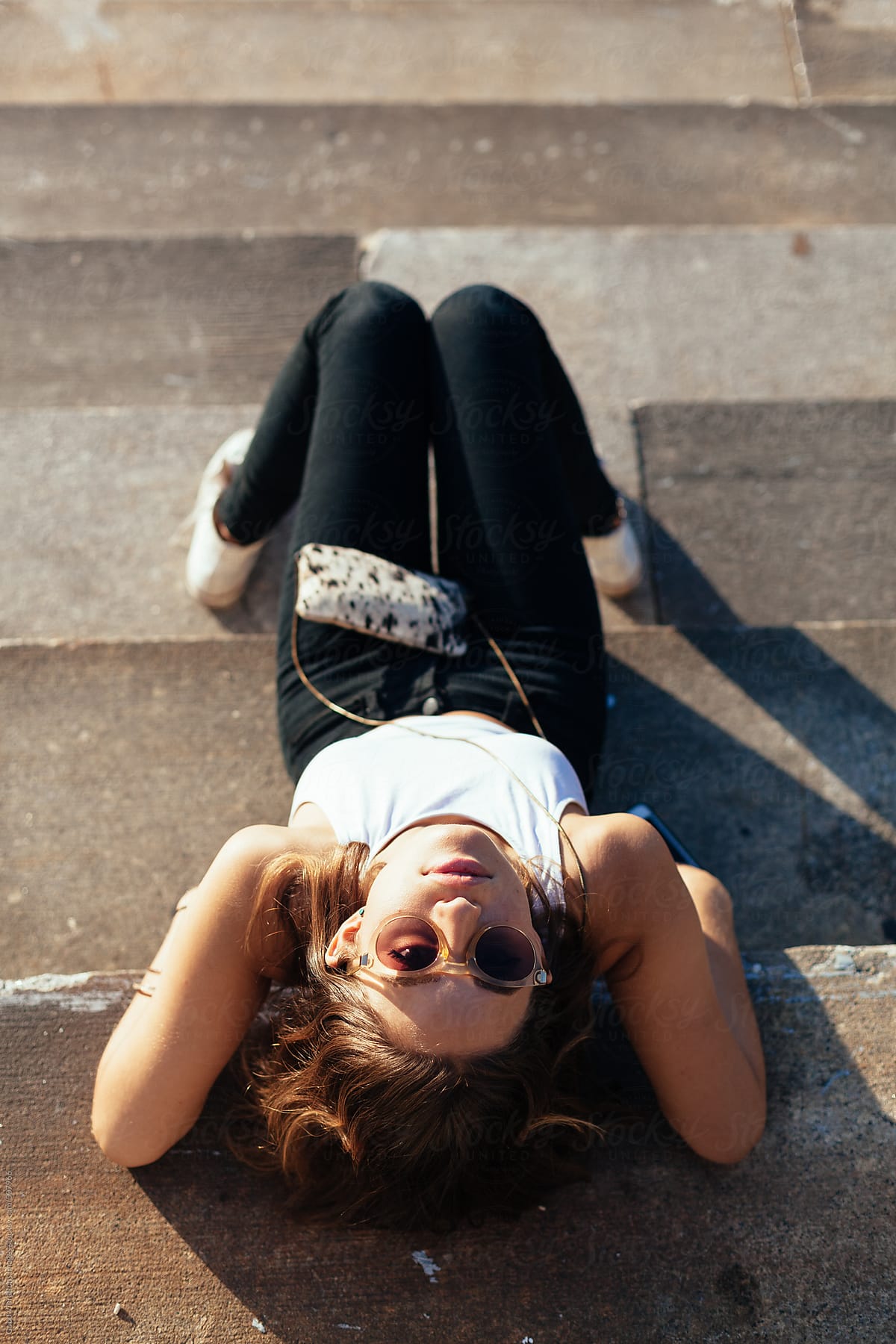 Brunette Sitting On Steps Outdoors By Stocksy Contributor Vero Stocksy