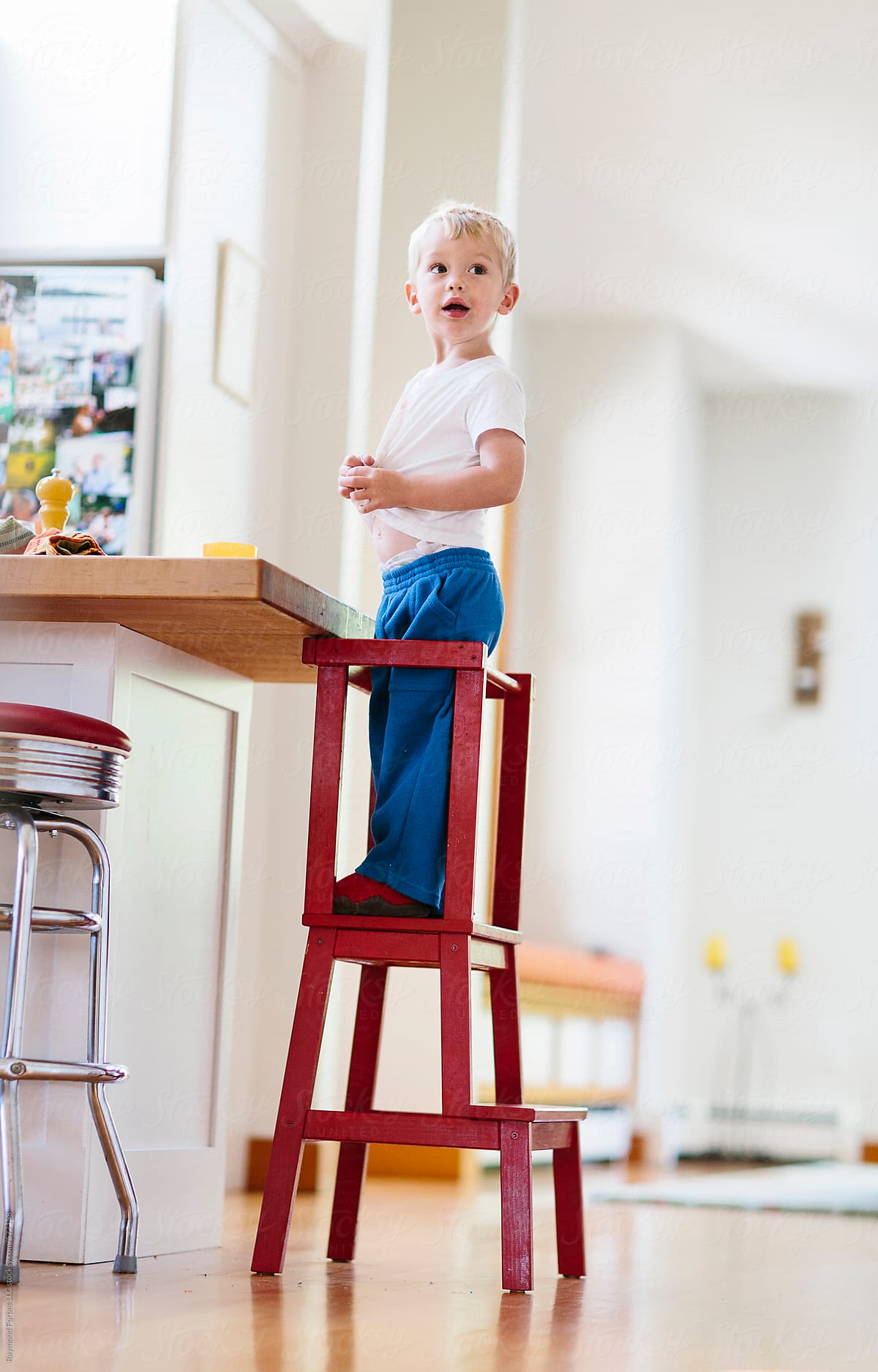 "Boy In Kitchen On Step Stool" by Stocksy Contributor "Raymond Forbes ...