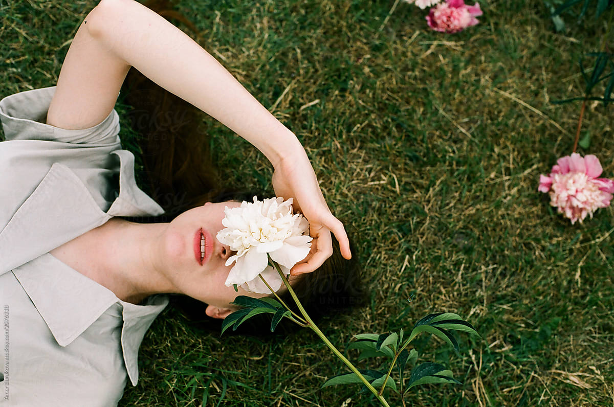 "Woman Hides Her Face Behind The Flower" by Stocksy Contributor "Amor ...