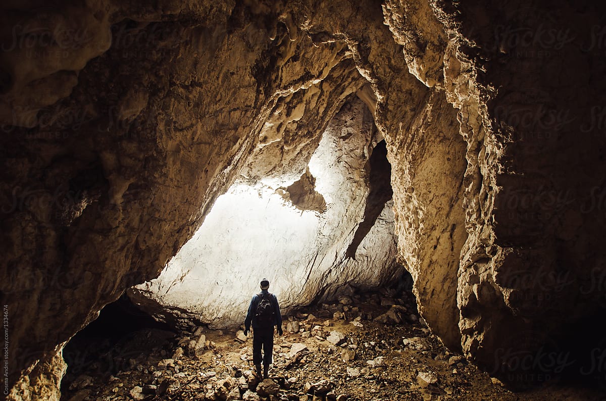"Man In Mountain Cave" by Stocksy Contributor "Cosma Andrei" - Stocksy