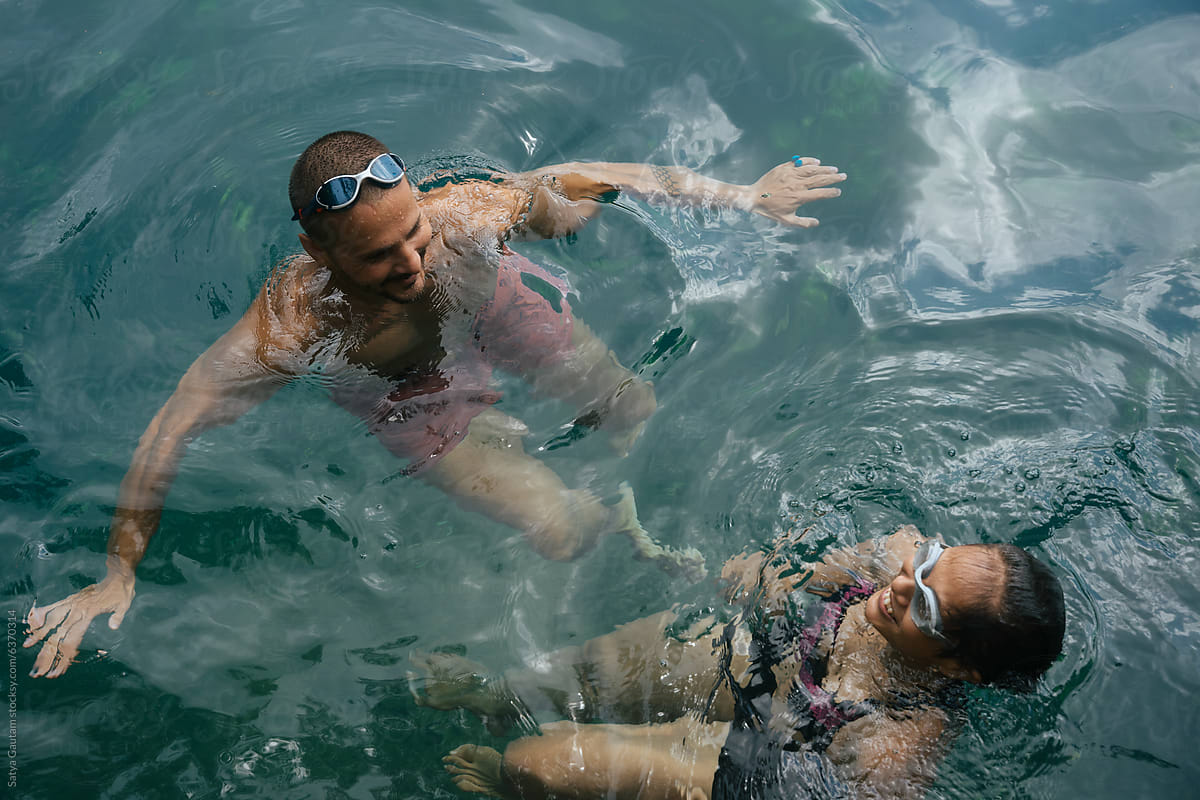 "Friends Enjoying A Swim In Clear Lake Water" by Stocksy Contributor ...