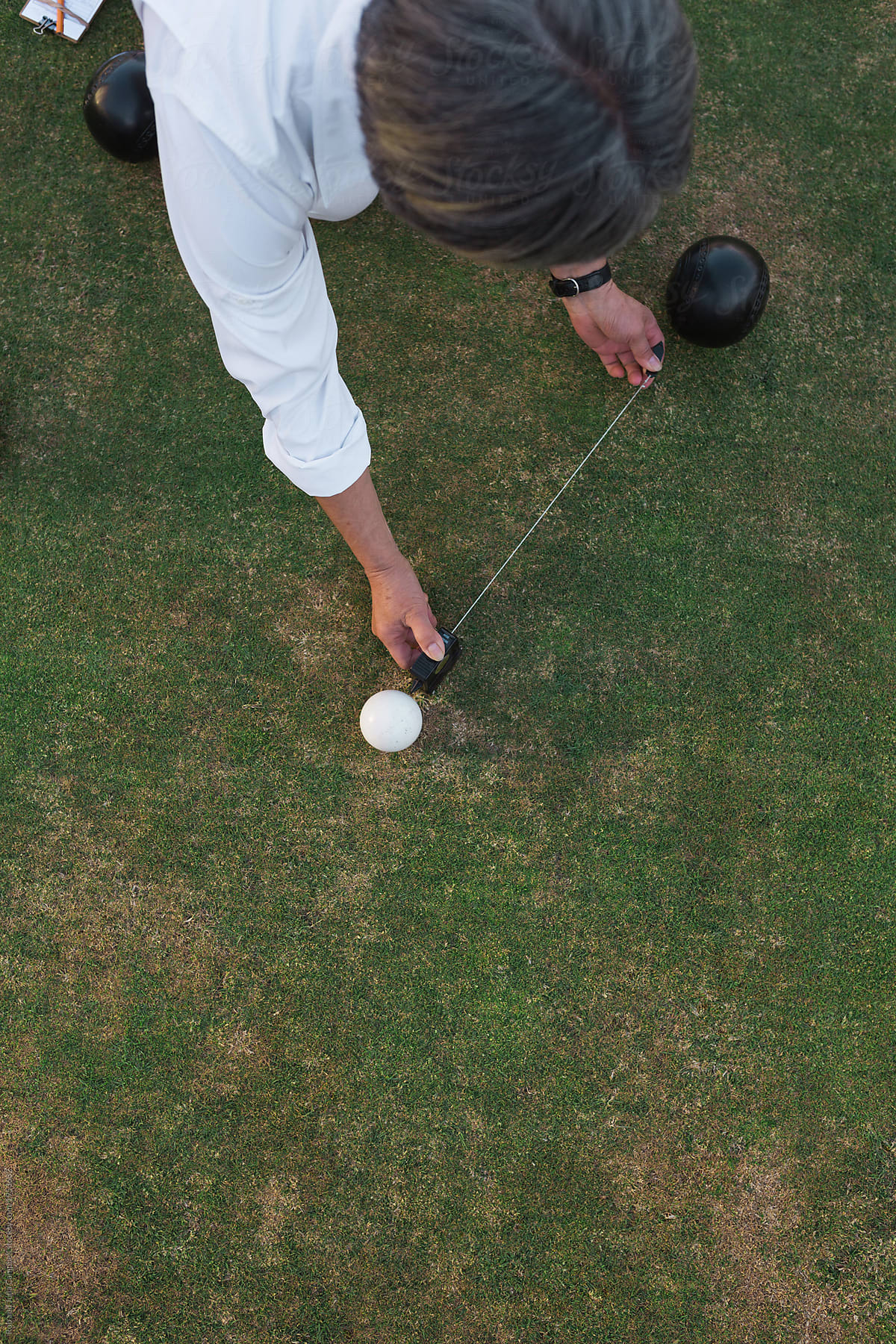 "Woman Measuring Lawn Bowling Distances" by Stocksy Contributor "Rob ...