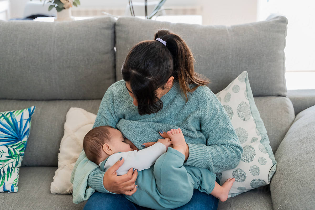 "Mother Breastfeeding Newborn At Home" by Stocksy Contributor "mahalo ...