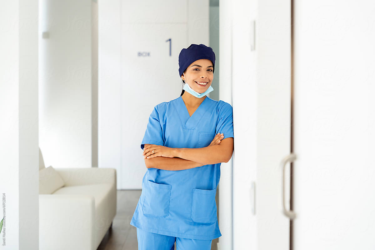 "Confident Latin Doctor Smiling In Modern Clinic Corridor" by Stocksy ...