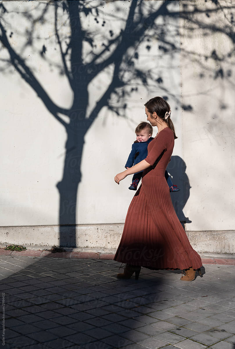 "Mother With Baby On Hands Under Tree Shadow" by Stocksy Contributor ...