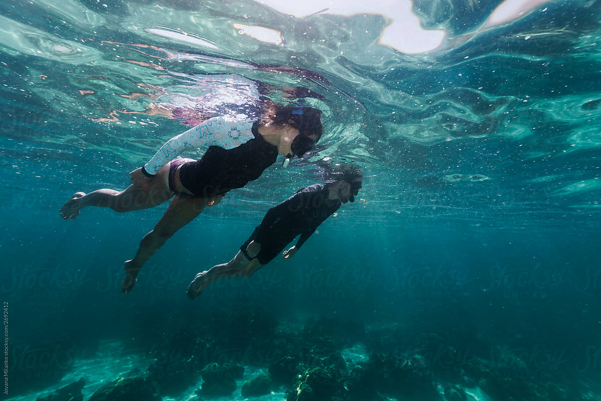 "Young Couple Exploring The Reef" by Stocksy Contributor "Jovana ...