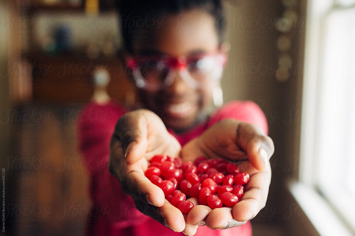 "Red Candy In The Palm Of An African American Girl" by Stocksy ...