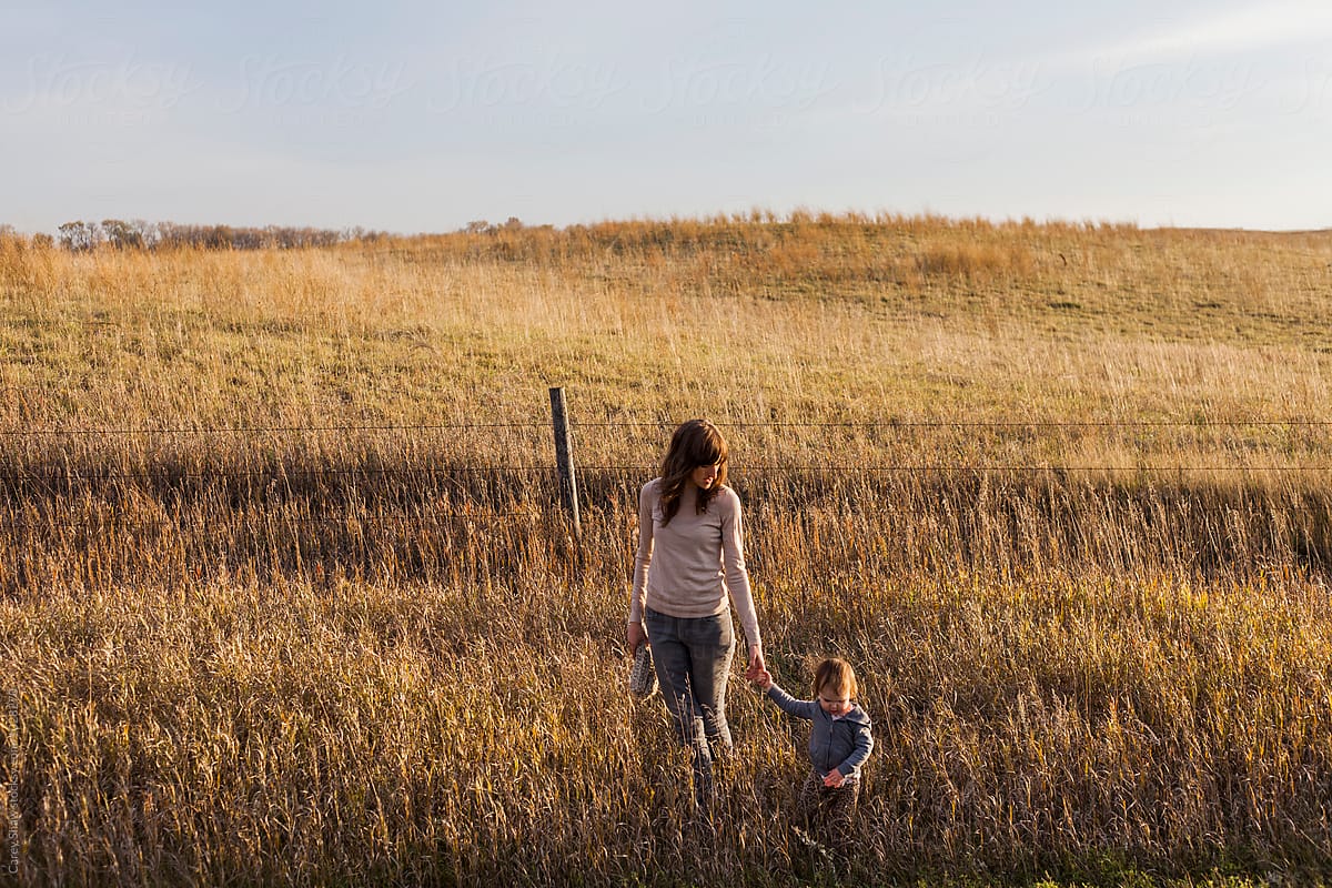 "Mother And Daughter Walking Together On Prairie Farm" by Stocksy ...