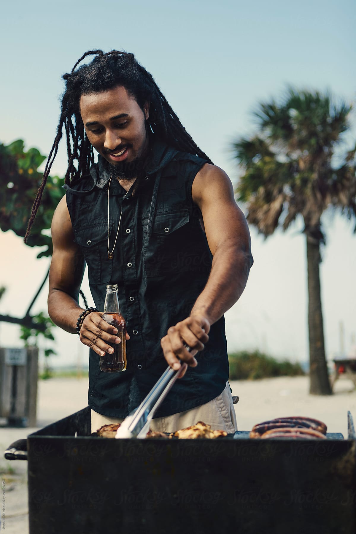 "Man Grilling Steak At The Beach" by Stocksy Contributor "Stephen ...