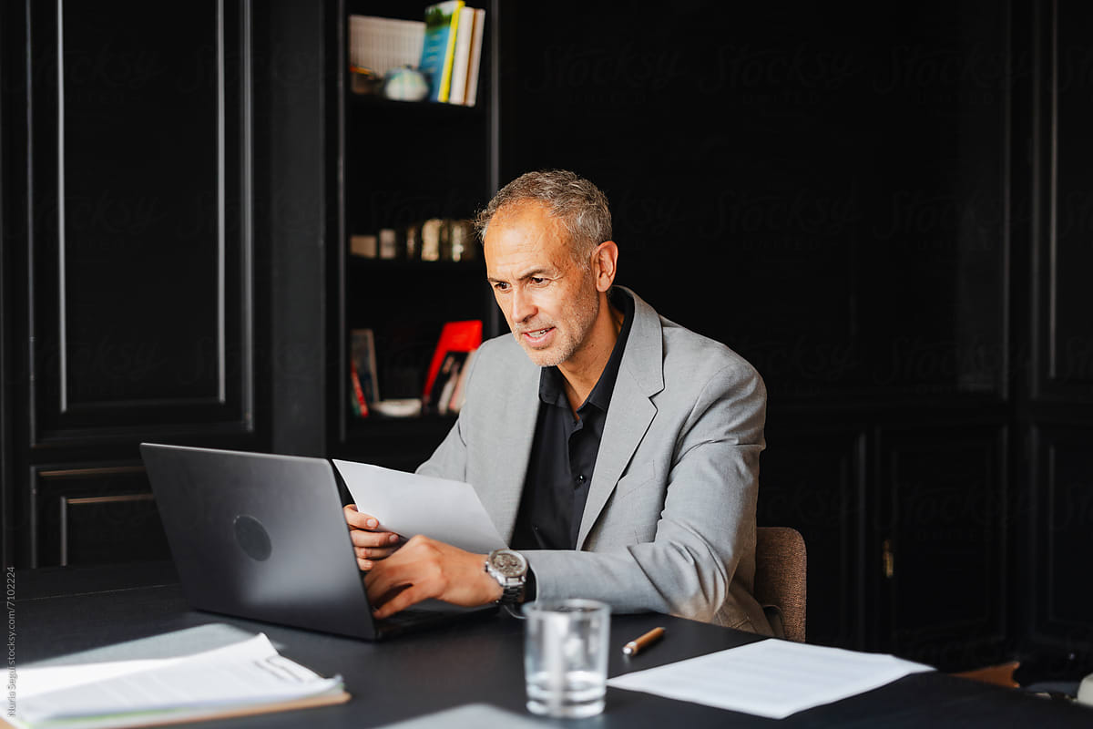 "Man Doing Paperwork At The Office" by Stocksy Contributor "Nuria Seguí ...