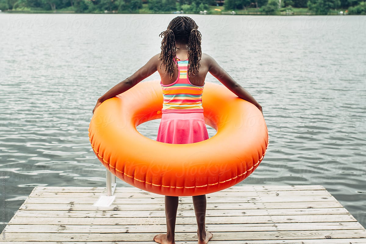 "Black Girl Holding An Orange Lifesaver" by Stocksy Contributor "Gabi ...