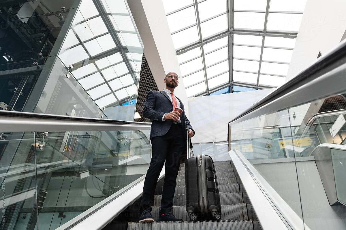 "Bald Manager Standing On Escalator In Airport" by Stocksy Contributor ...