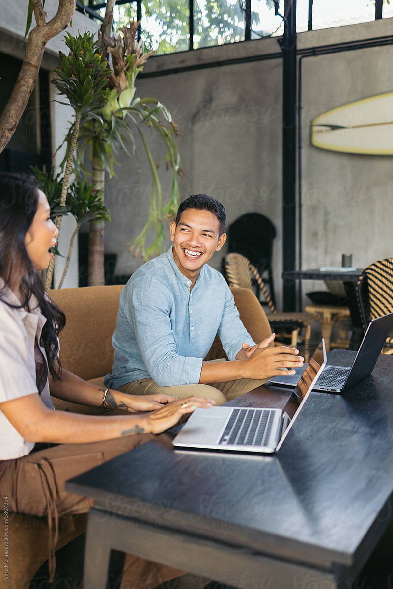 Cheerful people working online in an coworking space - Stock Image ...