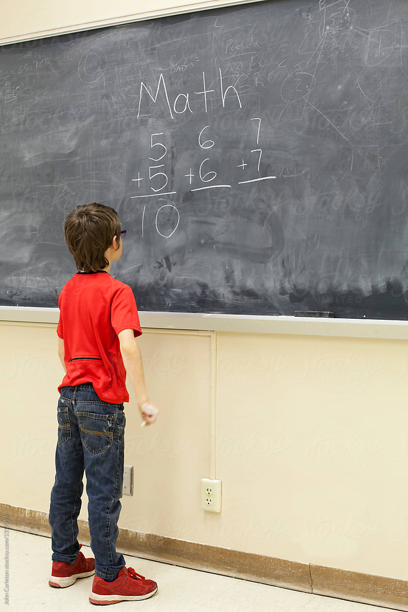  Boy Solves Math Problems On The Chalkboard In The Front Of The