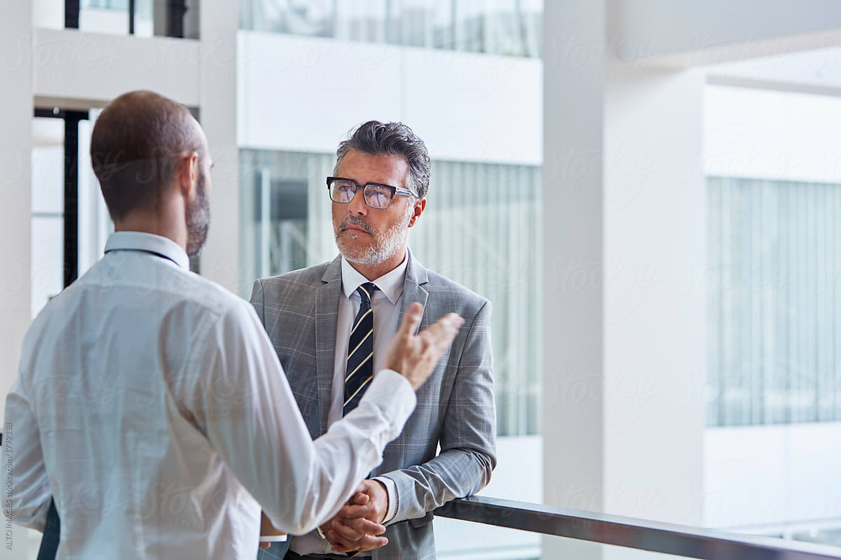 "Colleagues Talking While Standing By Railing" by Stocksy Contributor ...