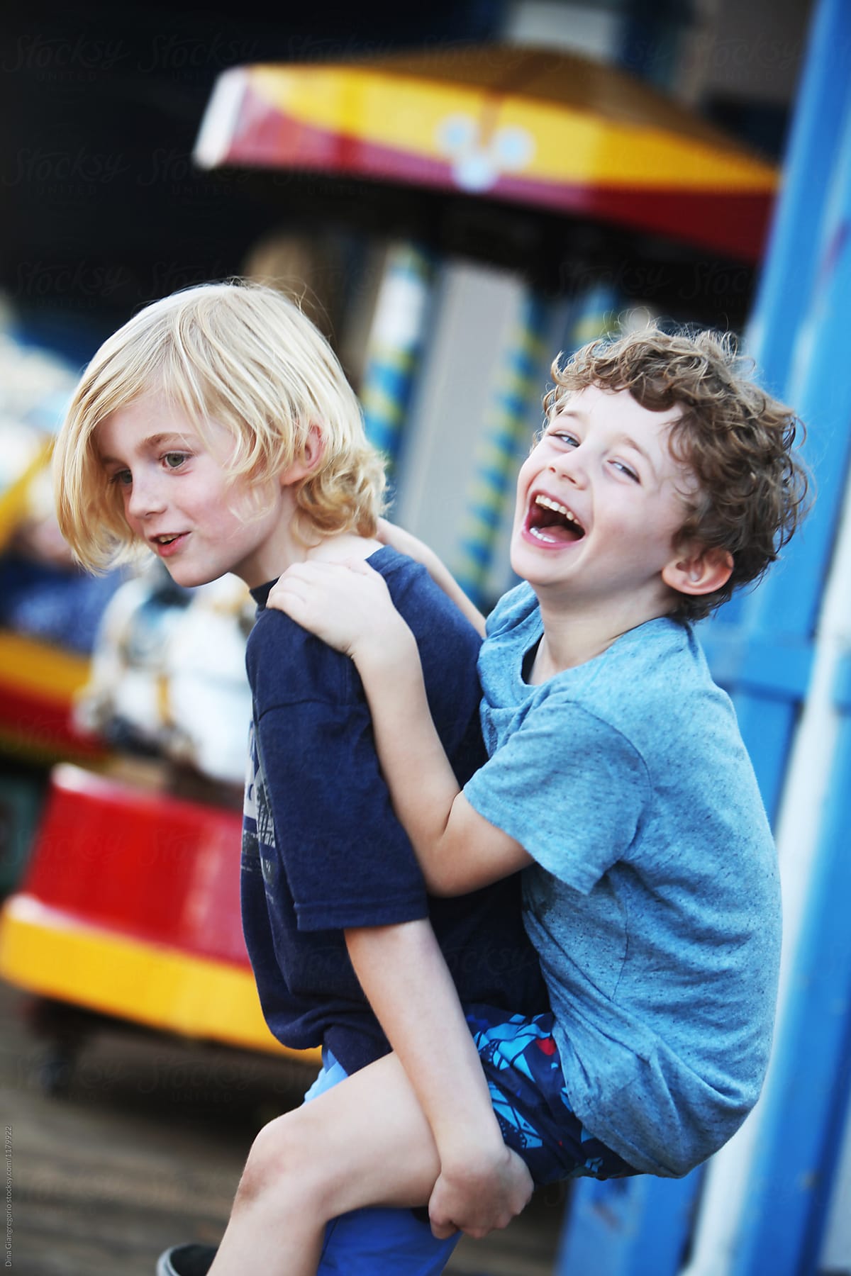 "Young Boy Holding Child On His Back" by Stocksy Contributor "Dina ...