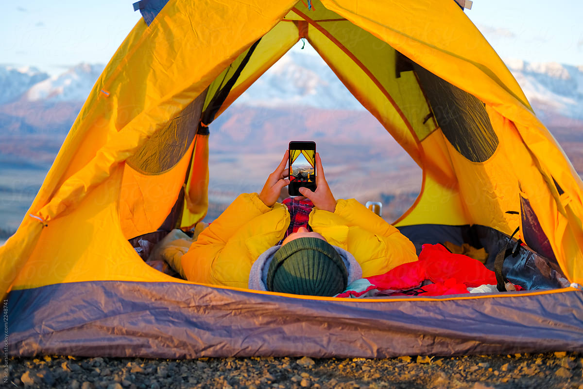 "Traveler In A Yellow Jacket Lies In A Tent" by Stocksy Contributor ...