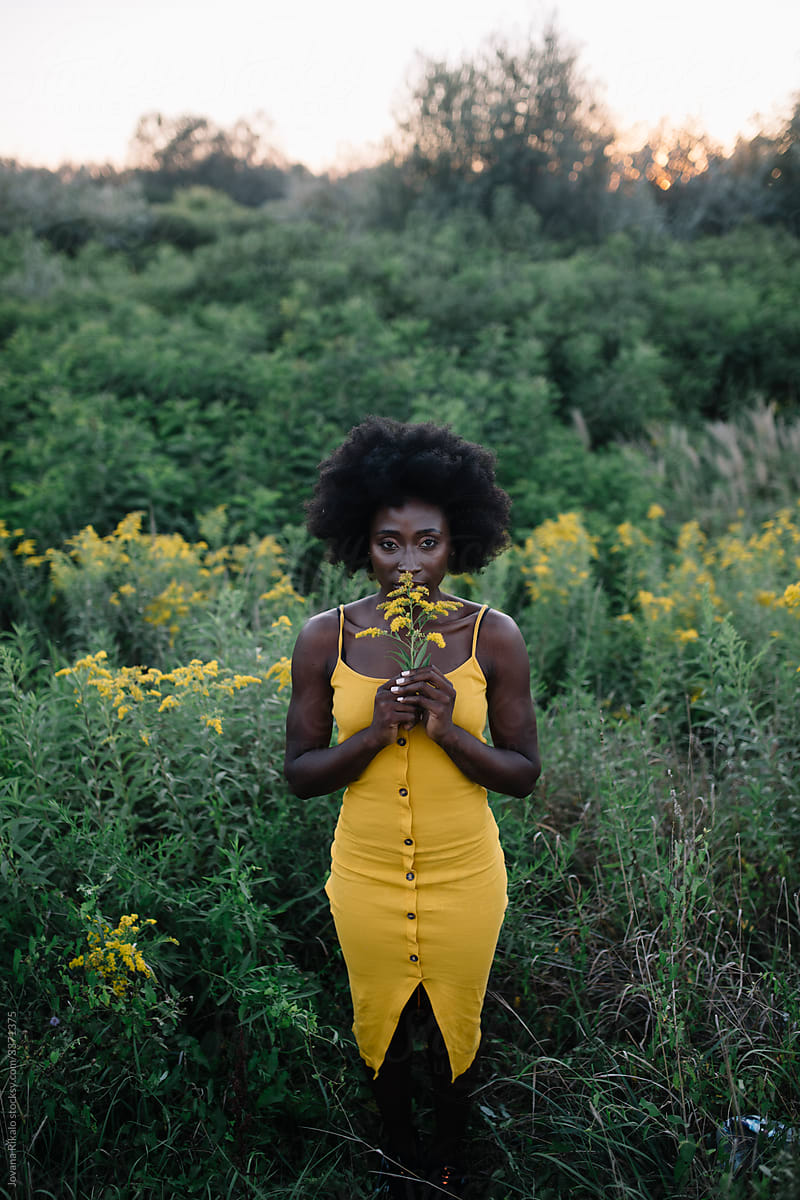 Portrait Of A Young Black Woman In A Yellow Flower Field By Stocksy Portrait Of A Young Black Woman In A Yellow Flower Field By Stocksy