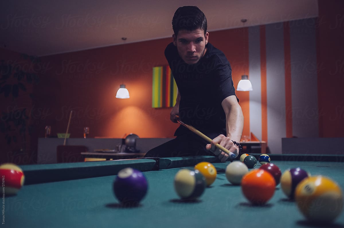 "Man Is Playing Billiard Game" by Stocksy Contributor "Tomas Mikula ...