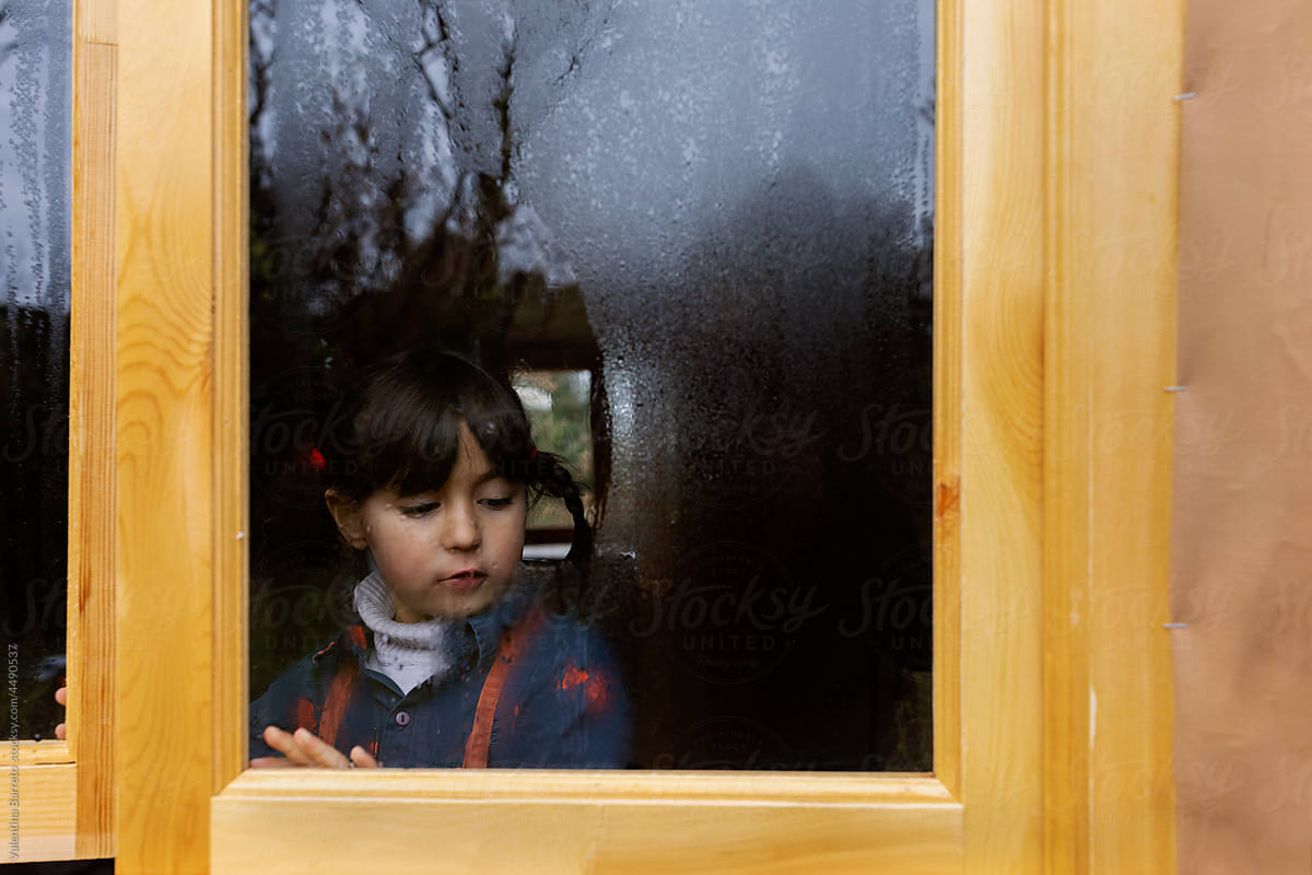 "Child Stares Out Of Window In Wooden House" by Stocksy Contributor ...
