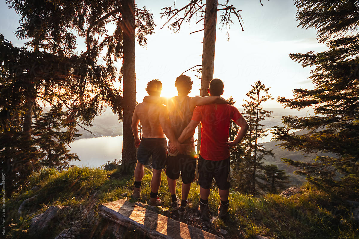 "Three Male Friends Enjoying Sunset On A Mountain With Beautiful ...