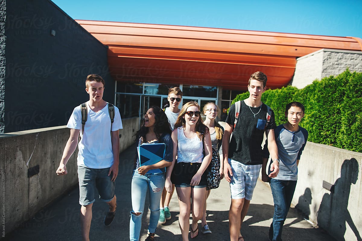 "Group Of High School Teens Walking Out Of School On Last Day" by ...