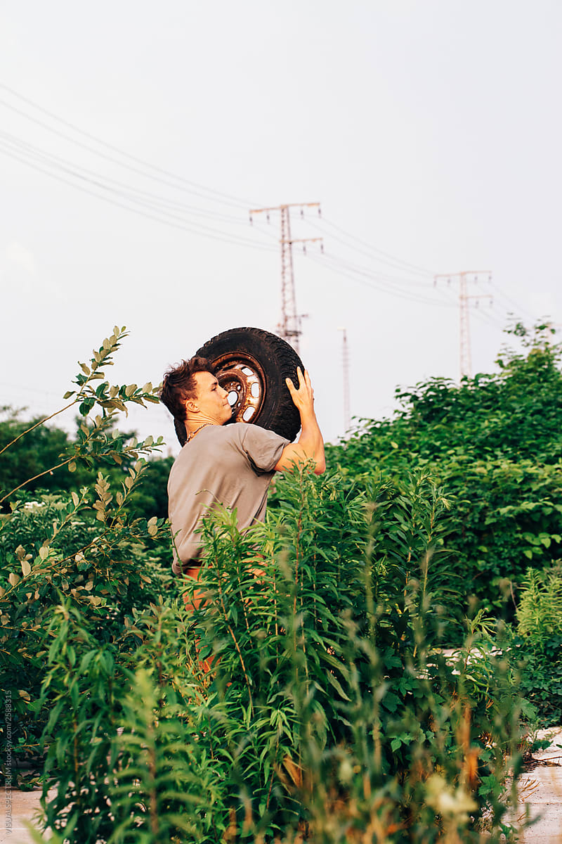 "Strong Young Guy Throwing Old Car Tire" by Stocksy Contributor ...