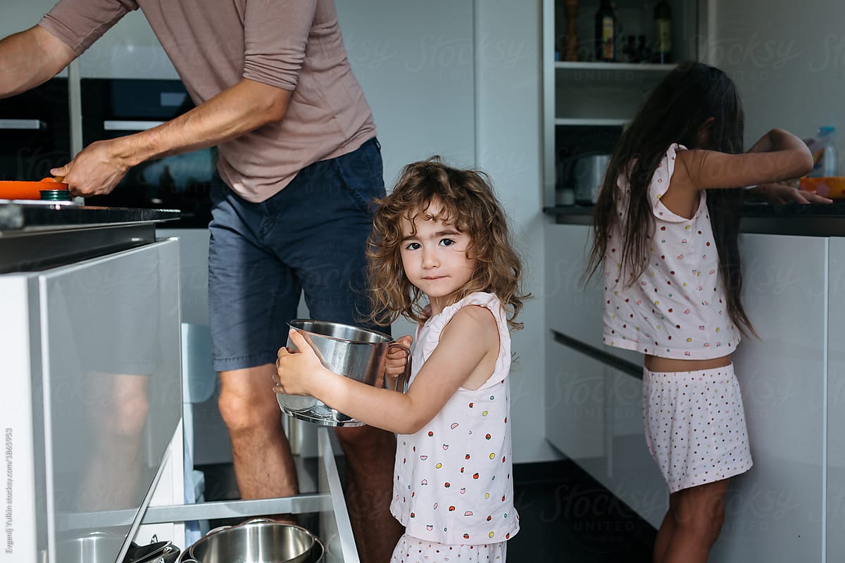 "Little Girl Helps Dad" by Stocksy Contributor "Evgenij Yulkin" - Stocksy