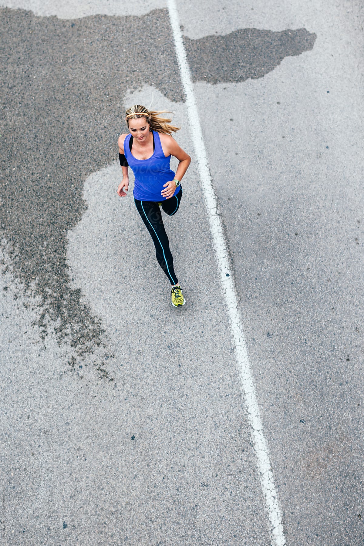 "Aerial View Of A Young Woman Running On A Road." by Stocksy ...