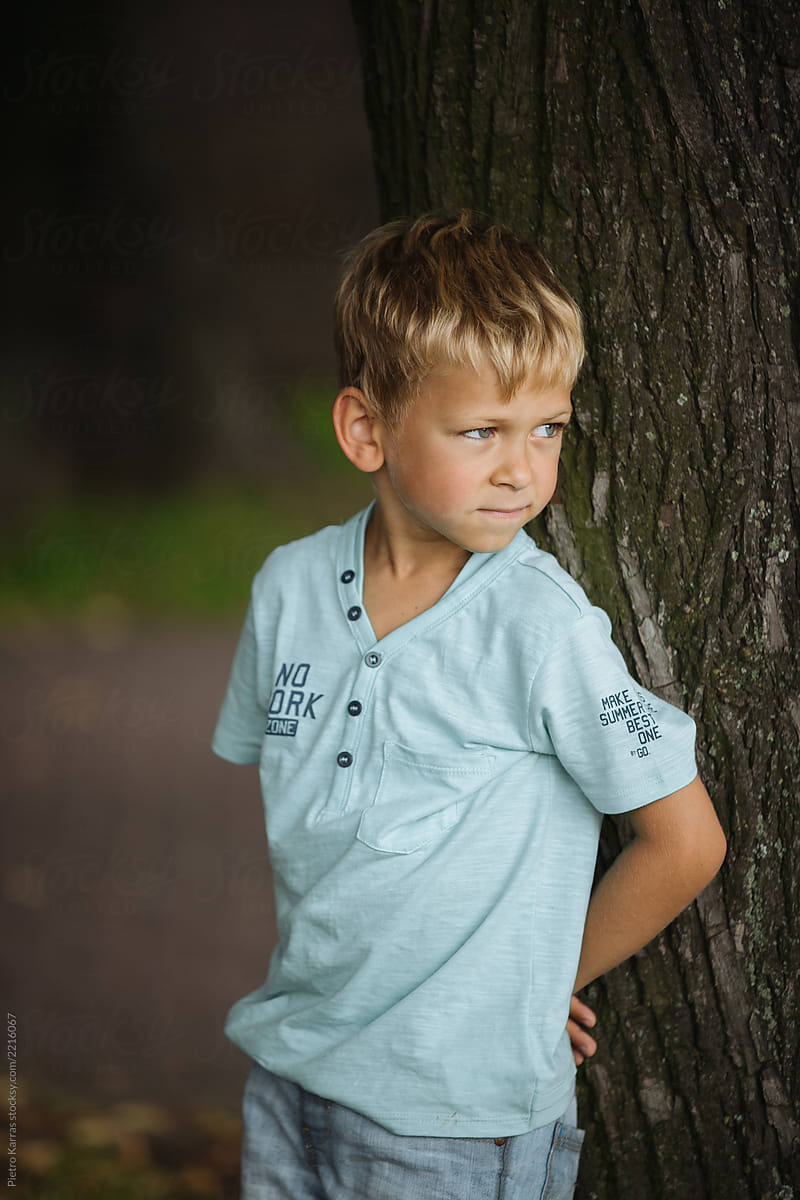 "Little Serious Boy Leaning On Tree" by Stocksy Contributor "Pietro ...