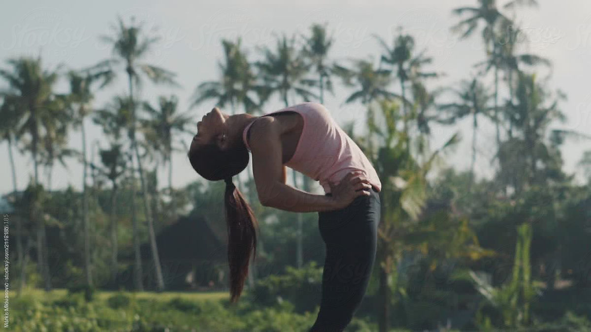 "Woman Performs Back Stretching" by Stocksy Contributor "Marko" - Stocksy