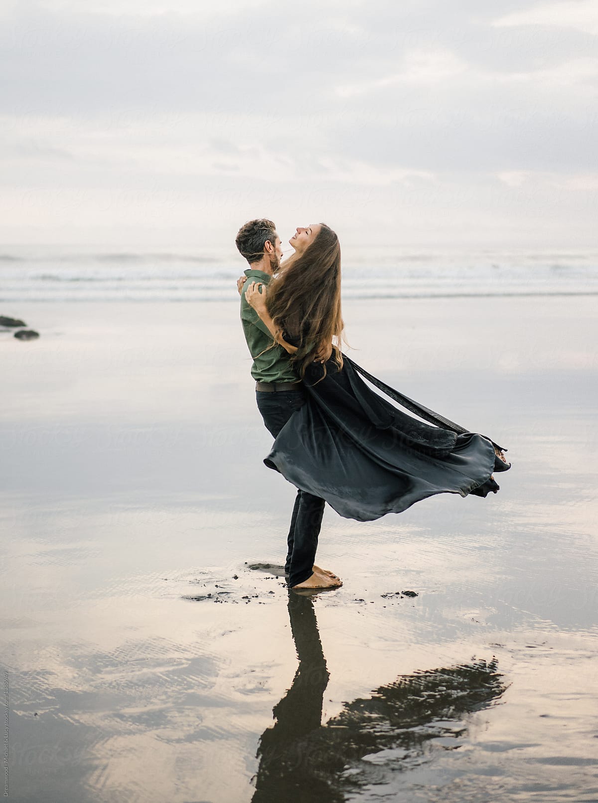 "Male Spinning Female On Beach" by Stocksy Contributor "Dreamwood ...