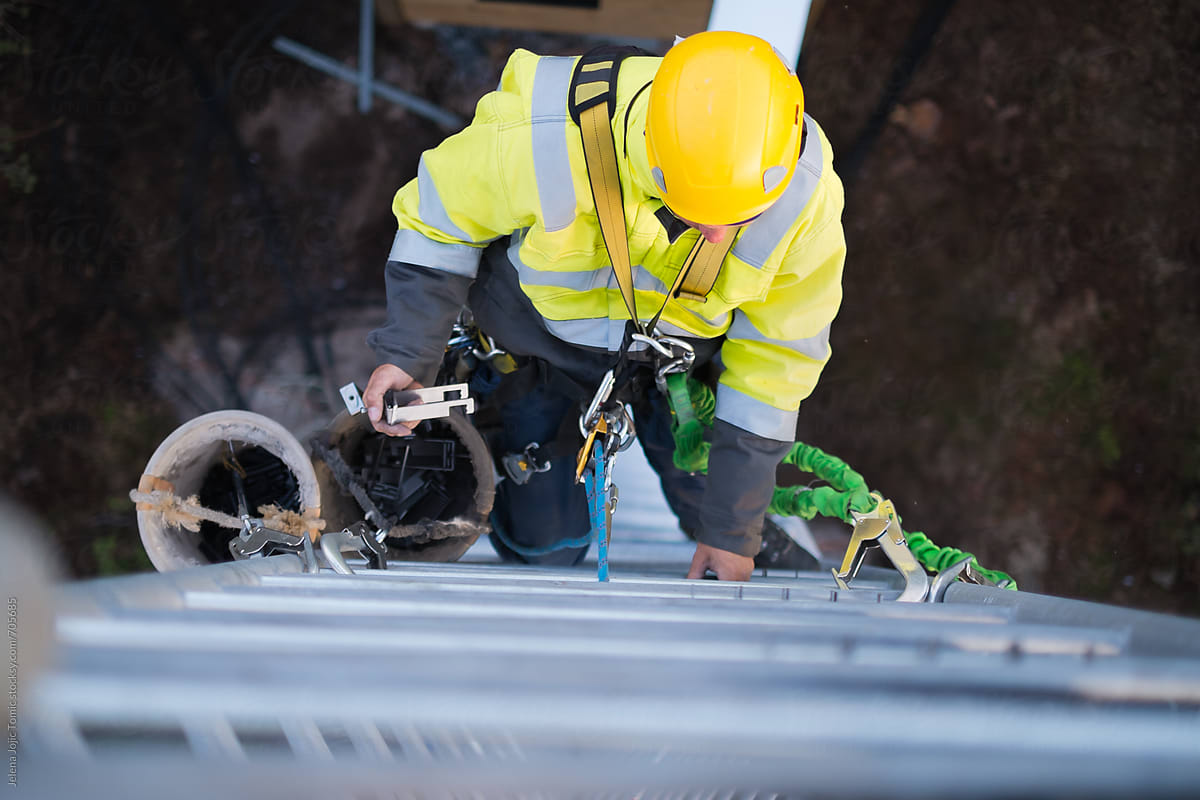 "Working At Heights, Technician Climbs Up On A Communications Tower" by ...
