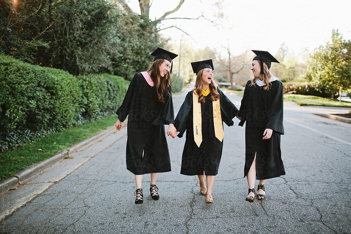 "Female Graduates Walking" by Stocksy Contributor "Erin Drago" - Stocksy