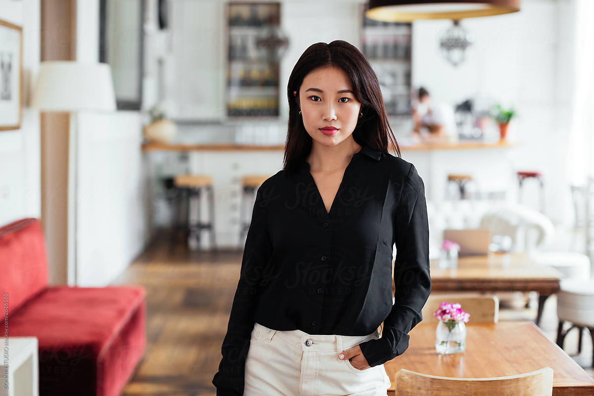 "Confident Asian Woman In Cafe" by Stocksy Contributor "BONNINSTUDIO ...