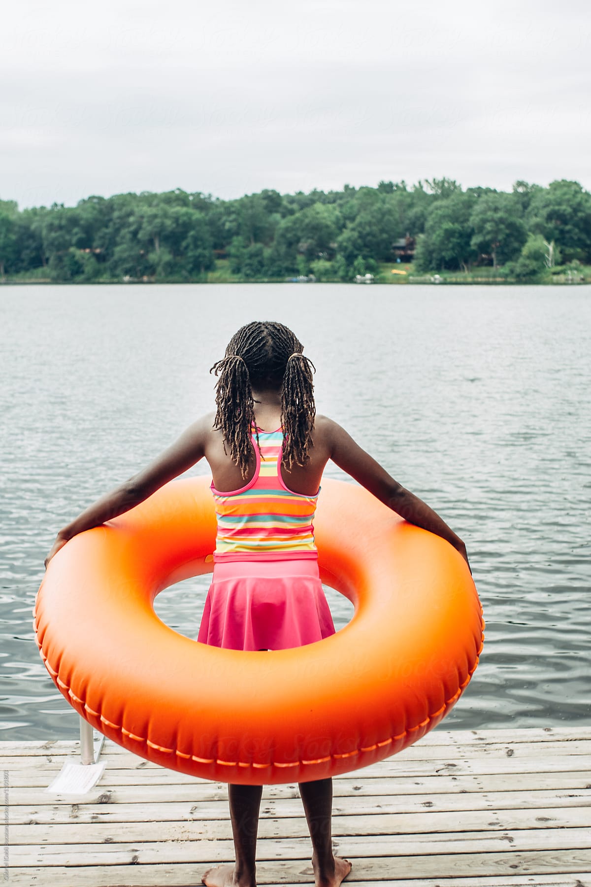 "African American Girl With An Orange Lifesaver" by Stocksy Contributor ...