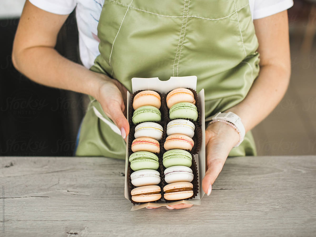 "Holding Macrons" by Stocksy Contributor "Irina Efremova" - Stocksy