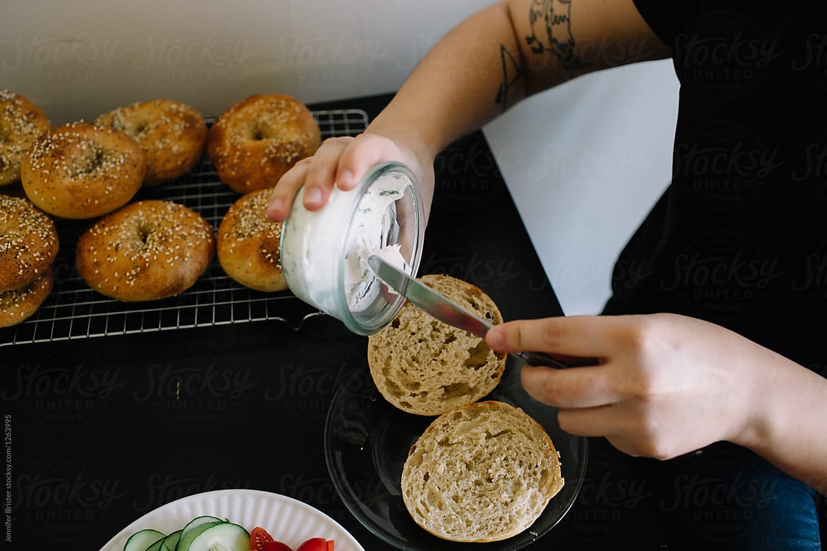 "Woman Making Bagel Sandwich" by Stocksy Contributor "Jennifer Brister ...