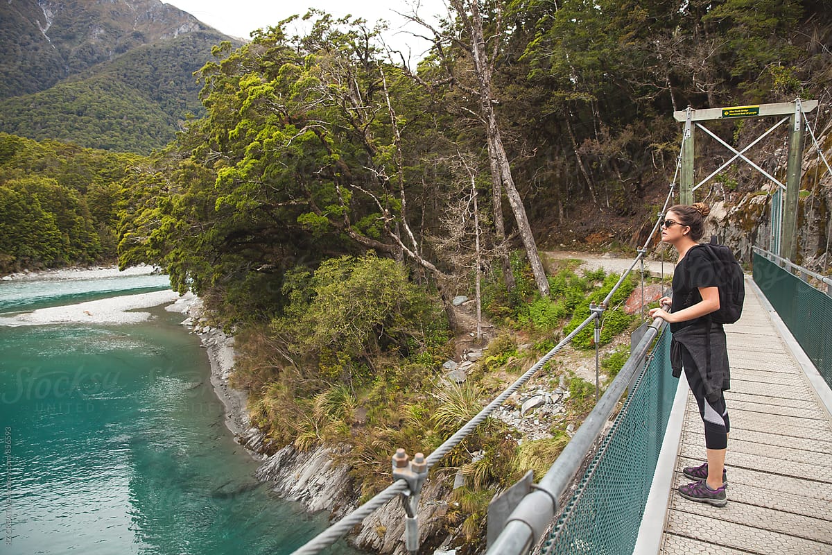 "Woman Standing On A Bridge At The Blue Pools Track In New Zealand." by ...