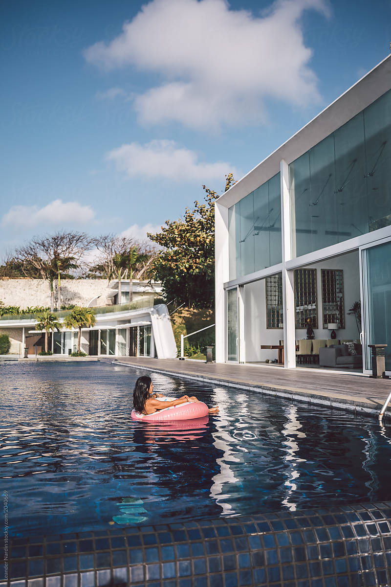 Sexy Woman Relaxing In A Big Pool On An Inflatable Pink Donut By Stocksy Contributor Akela