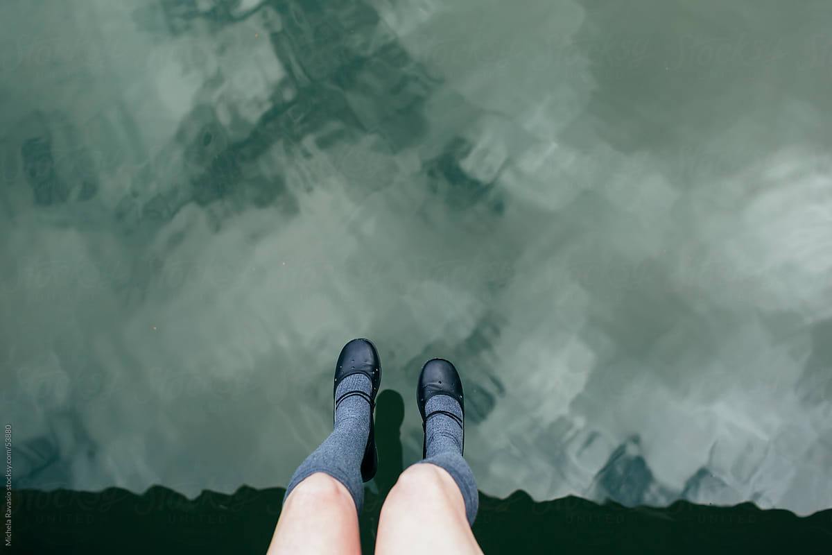 "Legs Dangling Over The River" by Stocksy Contributor "Michela Ravasio ...