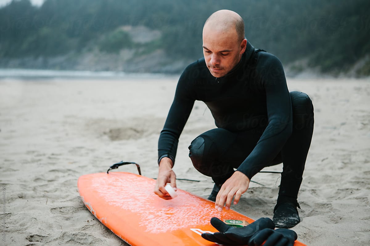 "Male Surfer Waxing His Surfboard" by Stocksy Contributor "Kristine ...