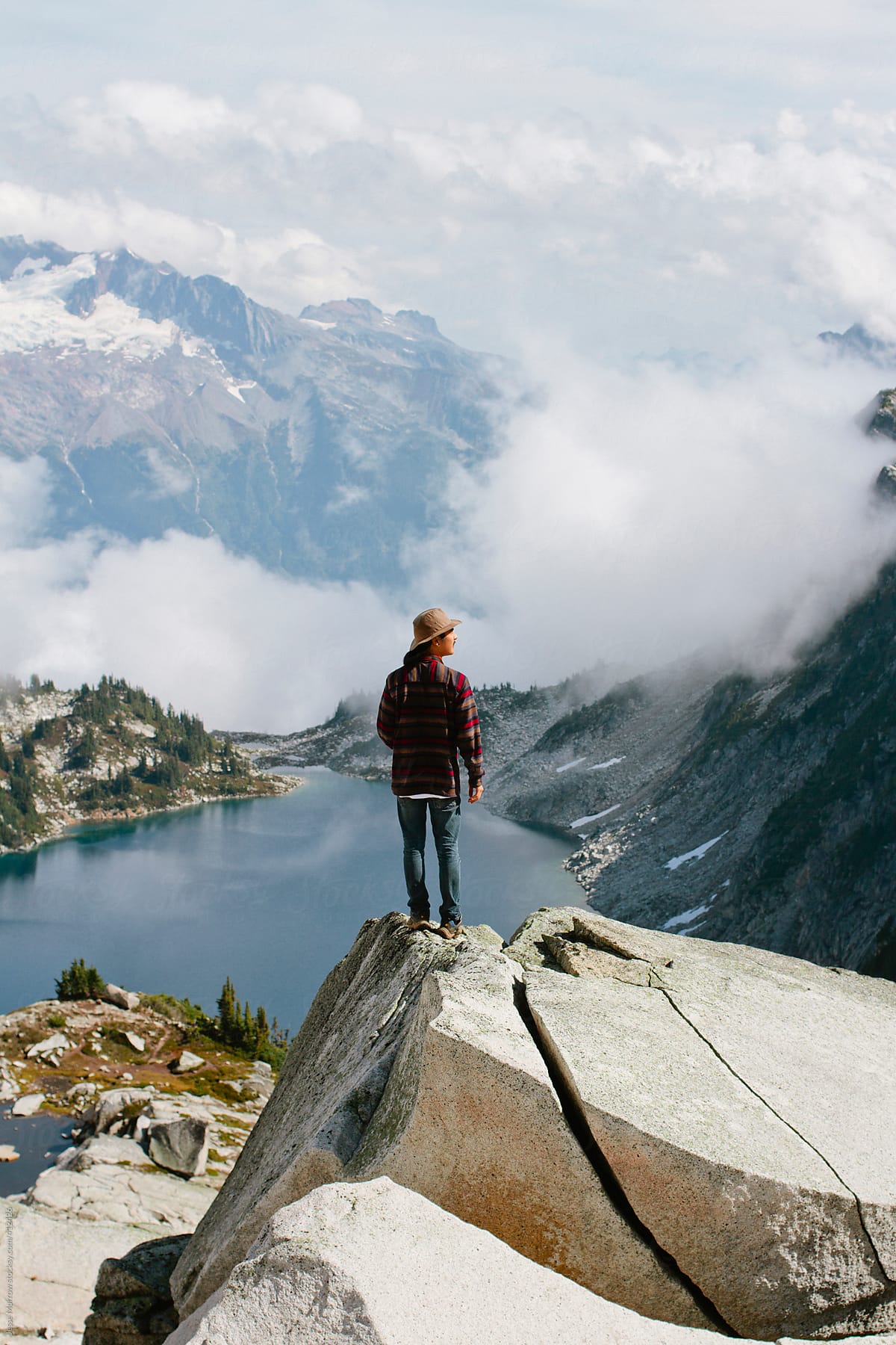 "Young Man Stands On Cliff Looking Out At Lake" by Stocksy Contributor ...