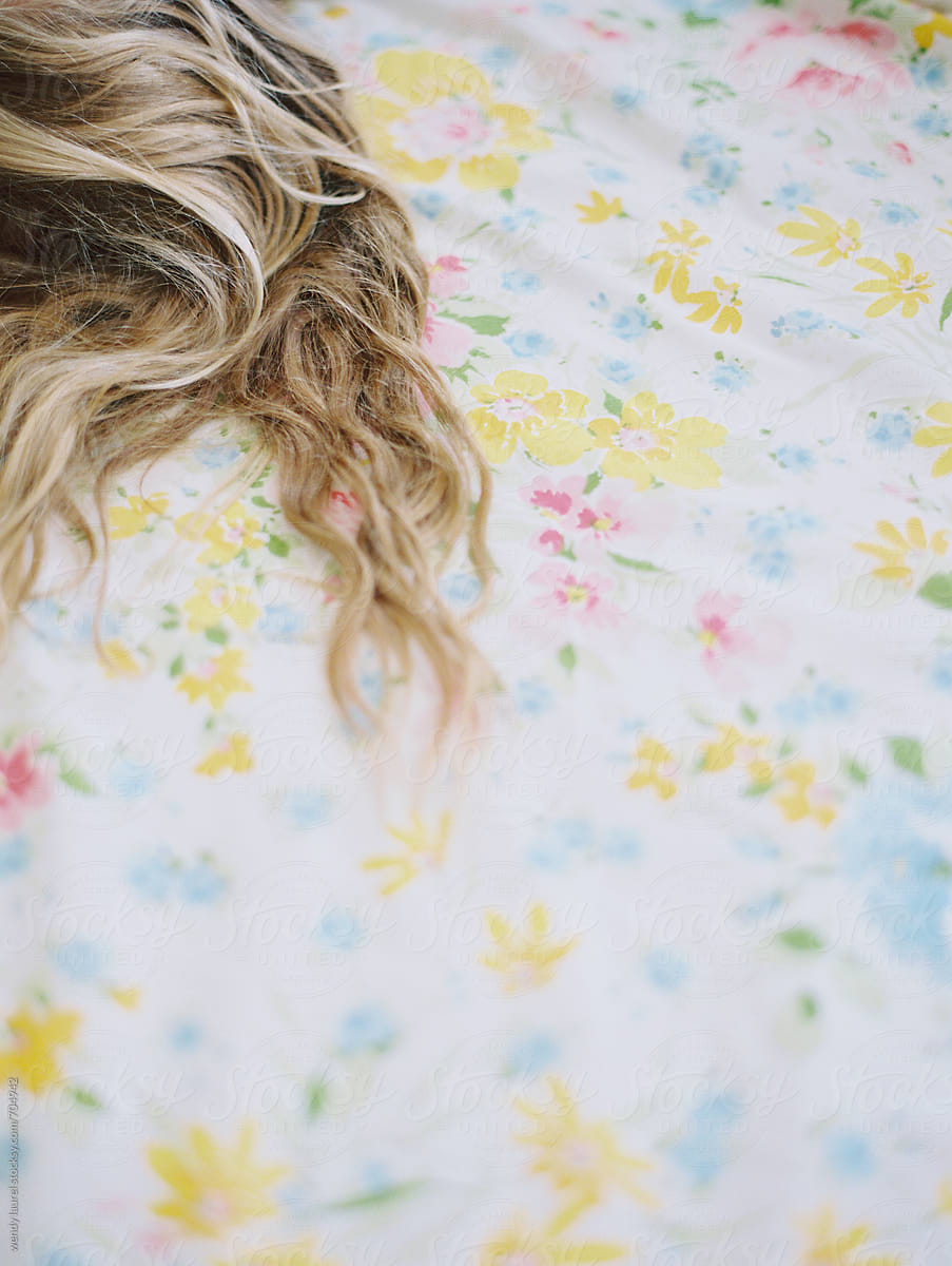 "Blonde Hair On Multi Colored Floral Vintage Sheets" by Stocksy ...