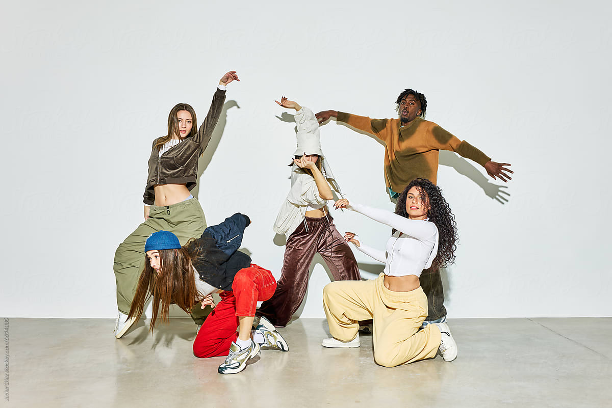 "Group Of Dancers Performing Dynamic Moves In A Studio Setting" by ...