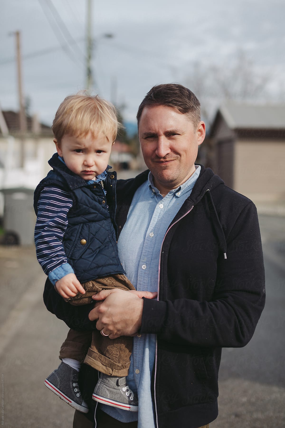 "Young Dad Holding Toddler Boy Outside On Street" by Stocksy ...