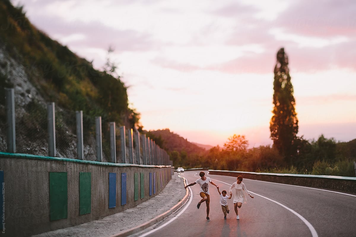 "Lively Family Running On The Road At Sunset" by Stocksy Contributor ...