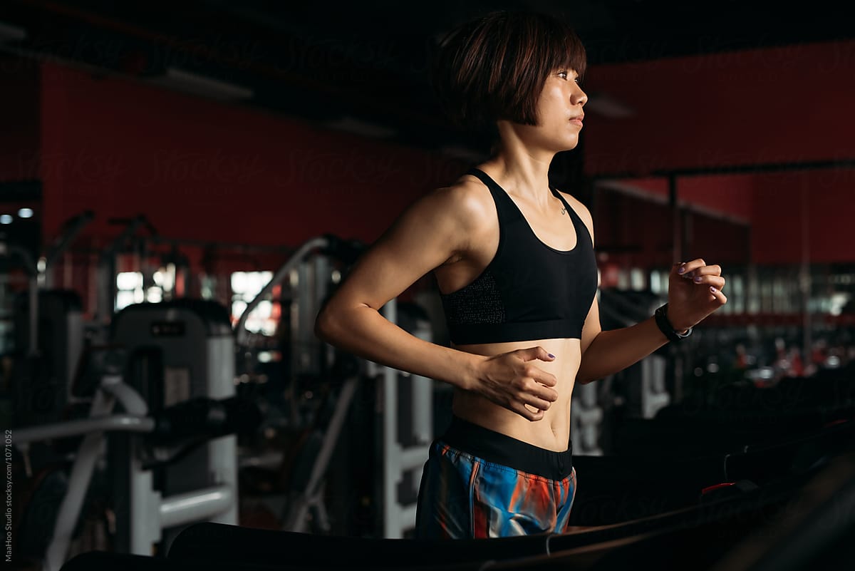 "Young Woman Running In Gym" by Stocksy Contributor "MaaHoo" - Stocksy